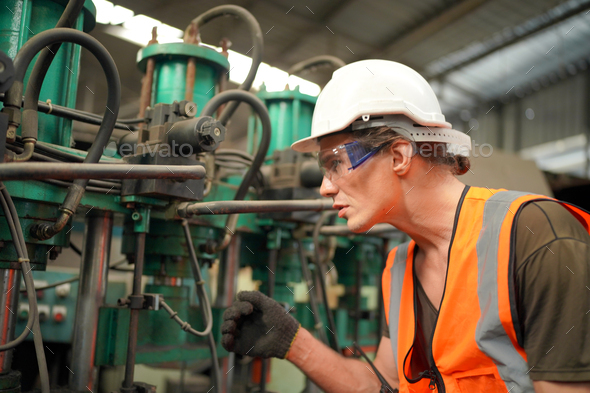 industrial mechanics engineer operating lathe machine for metalwork in ...