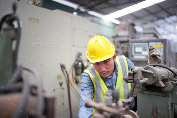 mechanics engineer operating lathe machine for metalwork in metal work ...