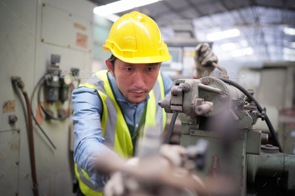 mechanics engineer operating lathe machine for metalwork in metal work ...