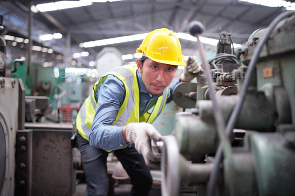 mechanics engineer operating lathe machine for metalwork in metal work ...