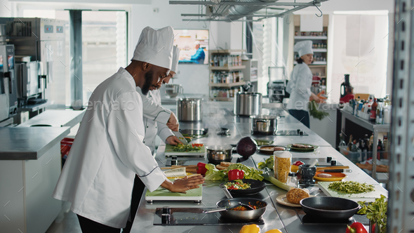African american cook using aromatic garlic clove to do culinary recipe ...