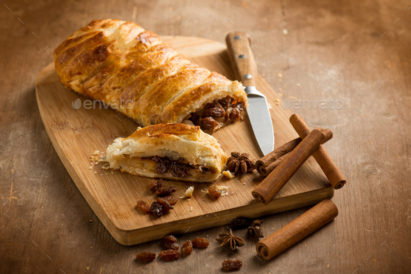 apple strudel with cinnamon stick and dried grape Stock Photo by MarcoMayer