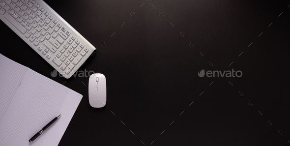 Computer keyboard and notepad on black paper background texture. Study ...