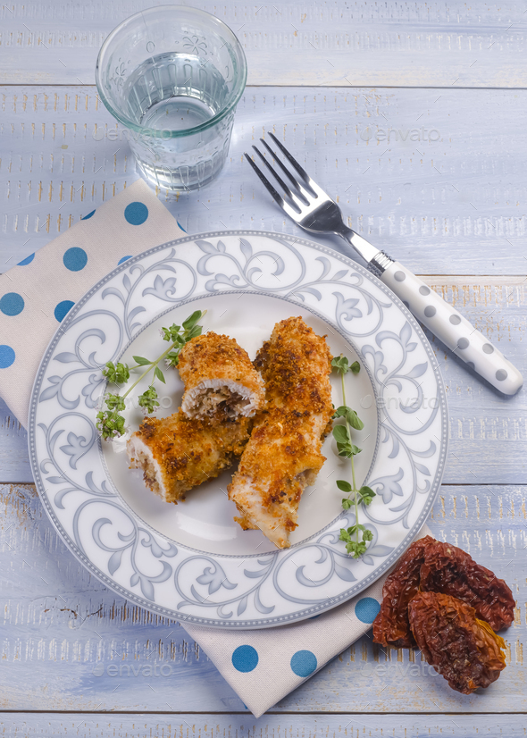 breaded swordfish stuffed with dried tomatoes Stock Photo by MarcoMayer