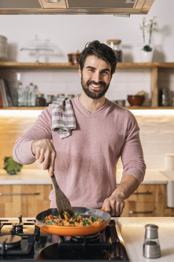 Handsome Man Cooking at Home Stock Photo by nunezimage | PhotoDune