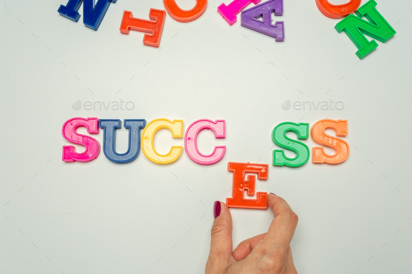 Word success written in colorful plastic letters on white background ...