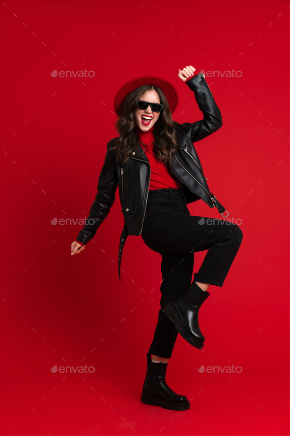 White woman in leather jacket laughing while dancing on camera Stock ...
