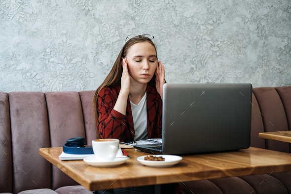 Student girl studying hard exam and sleeping on books in cafe. Tired ...