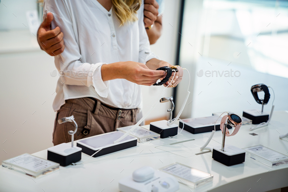 Happy young people buying new digital gadgets in store. Tecgnology ...