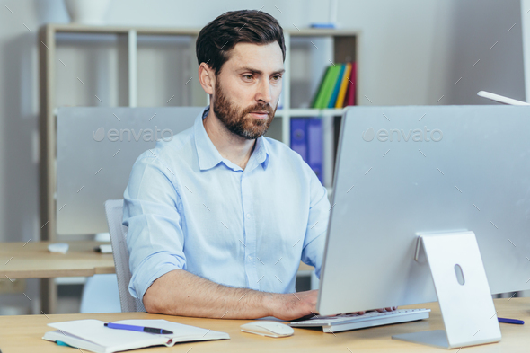 Portrait of a serious and focused businessman, a man working in a ...