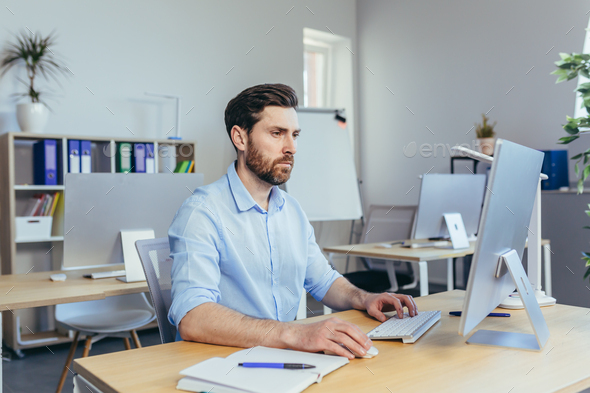Portrait of a serious and focused businessman, a man working in a ...