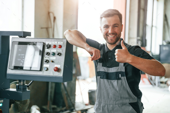 Standing near operate device. Man in uniform is in workstation ...