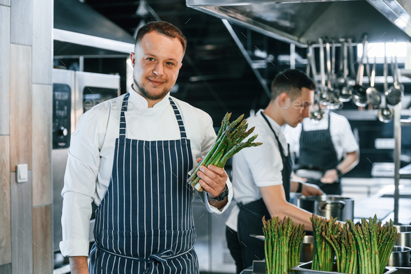 Professional employees. Kitchen workers is together preparing the food ...