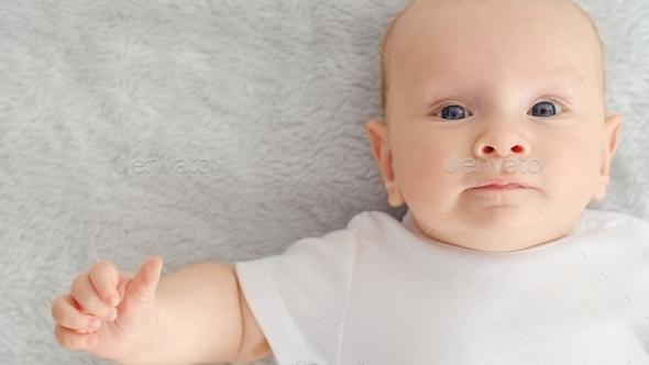 Child's face of a Happy newborn baby looking to camera. Stock Photo by ...
