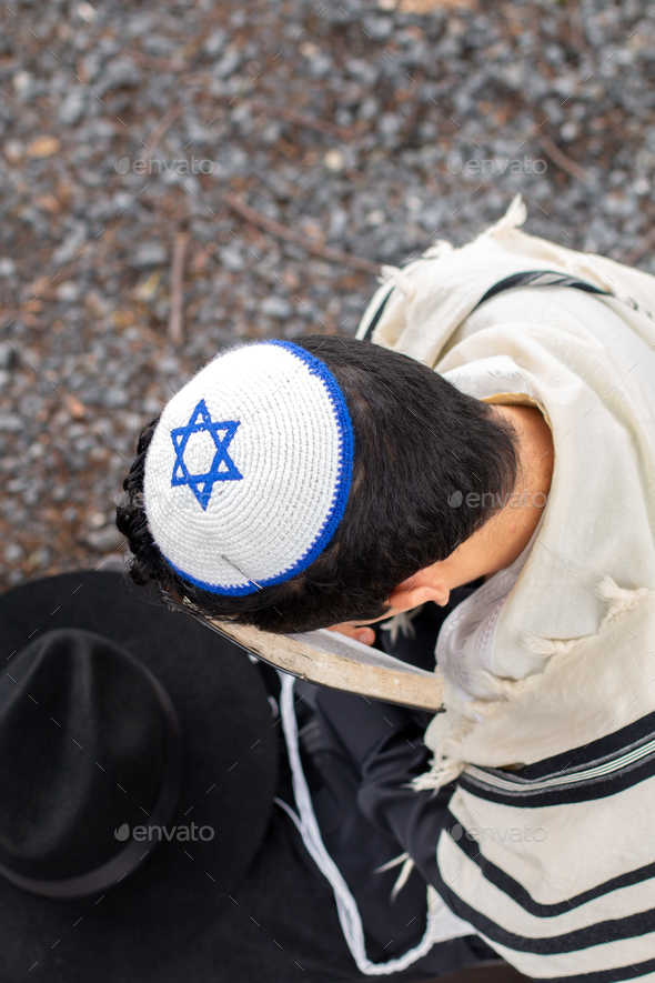 Photo taken from above of a Jewish man with kippah and taltit ...