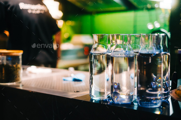 Glass bottles with water on the bar counter in asian restaurant. Stock ...