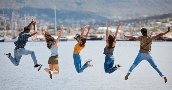 Rearview shot of a group of friends jumping together on a pier Stock ...