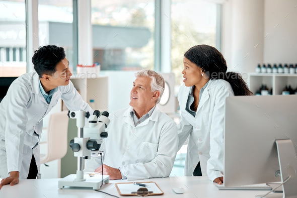 Shot of a group of scientists working together in a lab Stock Photo by ...