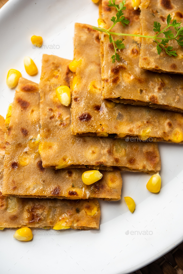 Sweet corn stuffed paratha or parotha served in a plate, Indian ...