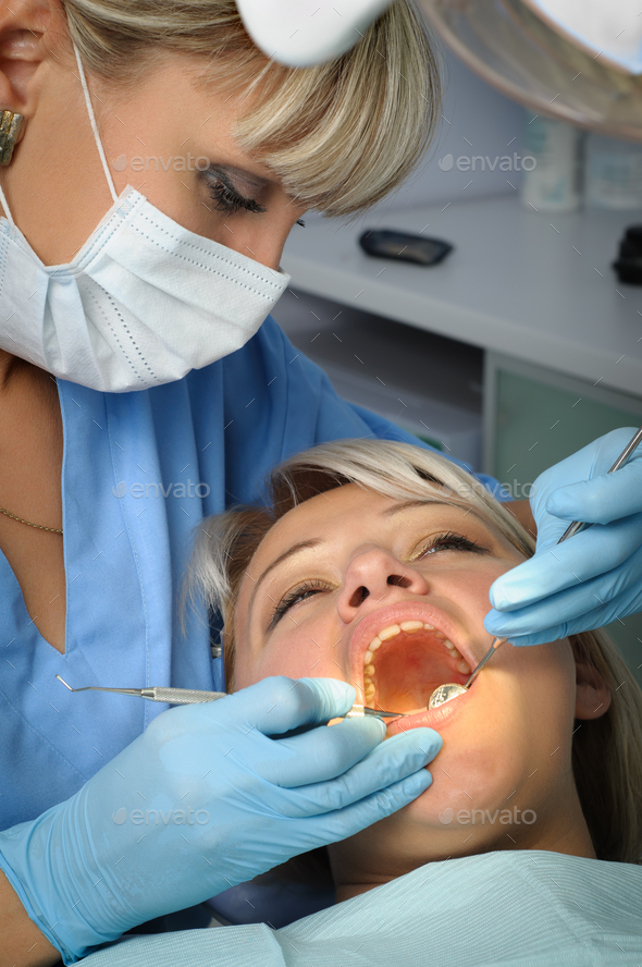 dentist with patient, dental calculus removal Stock Photo by staRRush
