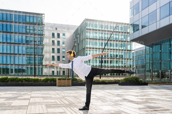 Flexible and cool businessman doing acrobatic trick Stock Photo by ...