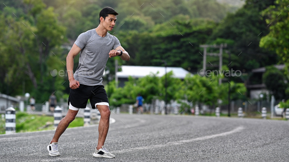 Full length of active young asian man jogging at the park in the ...