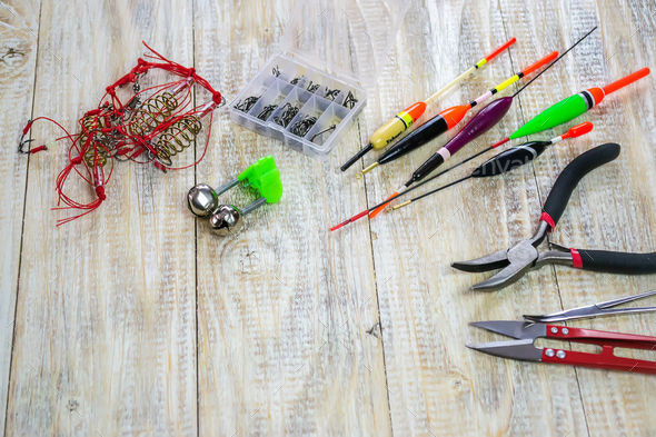 fishing tackles for anglers - swimmers, plummets and tools on wooden ...