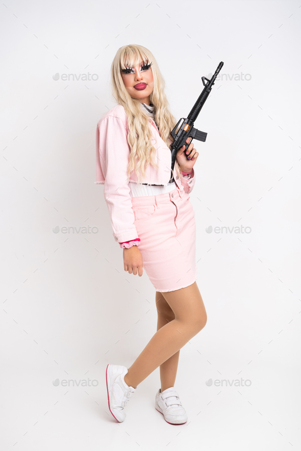Woman dressed as drag queen looking at camera with toy gun Stock Photo ...