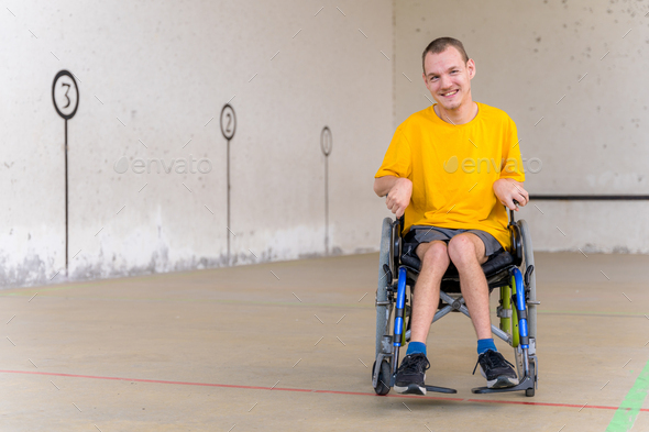 A disabled person in a wheelchair at a Basque pelota game fronton Stock Photo by Unai82