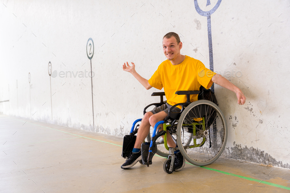 A disabled person in a wheelchair at a Basque pelota game fronton having fun Stock Photo by Unai82