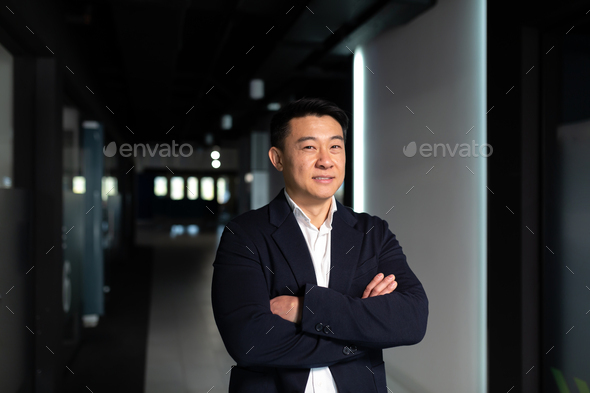 Portrait of a successful Asian manager boss, with crossed arms in a ...