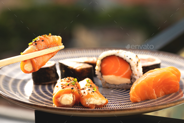 variety of sushi Maki, Inari, Sashimi, Nigiri, Uramaki, Gohan on plate ...