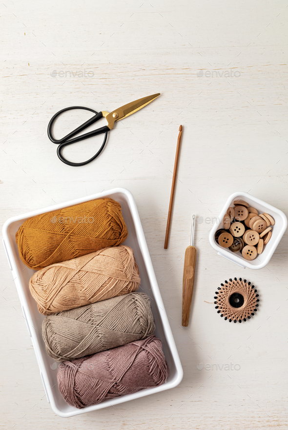 Craft hobby background with yarn in natural colors Stock Photo by OksaLy