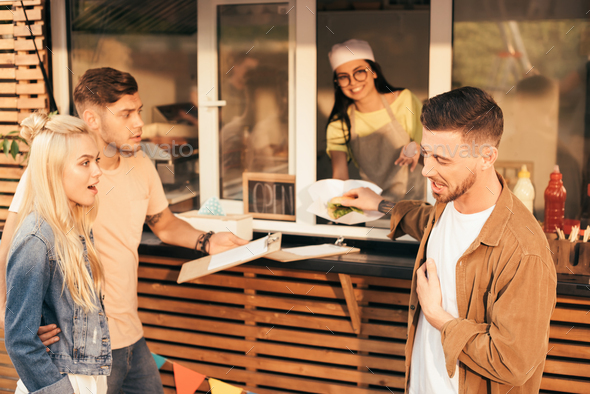 customer grimacing and rejecting burger from chef in food truck Stock ...