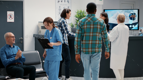 Busy reception desk with many patients waiting to attend consultation ...