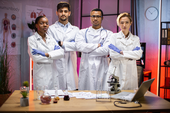 Smiling group of scientists in modern laboratory with male african ...