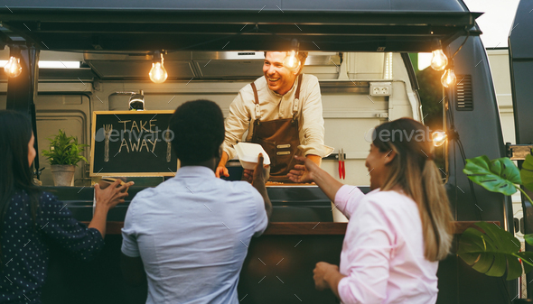 Multiracial people ordering food at counter in food truck outdoor ...