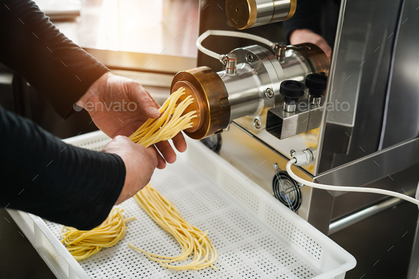 Man working with Pasta manufacture machine Stock Photo by DisobeyArtPh