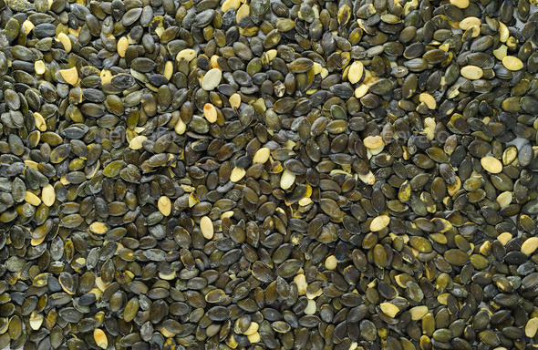 pumpkeen seeds scattered over stone board Stock Photo by staRRush ...