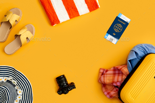 Flat Lay Shot Of Yellow Suitcase Unpacked With Holiday Accessories On ...