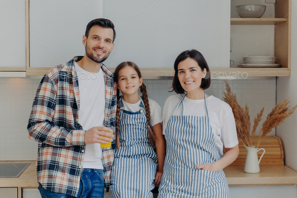 Happy family have great time together, pose in modern kitchen at home ...