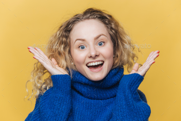 Overjoyed pretty amazed female model expresses positiveness, has happy ...