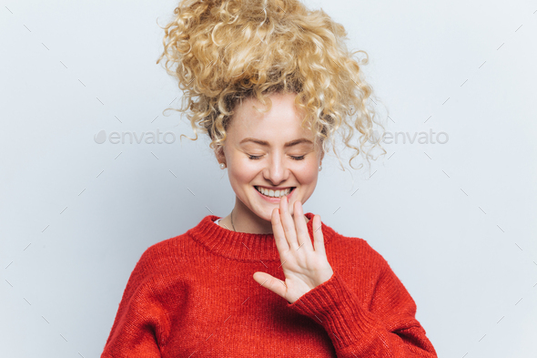 happy delighted young female with cheerful expression, keeps eyes shut ...