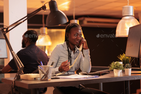 Company employee answering landline phone call to talk about business ...