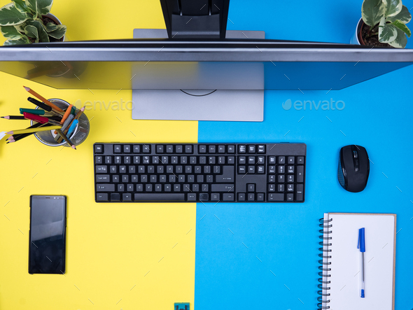 Flat lay top view of computer monitor over blue background Stock Photo ...