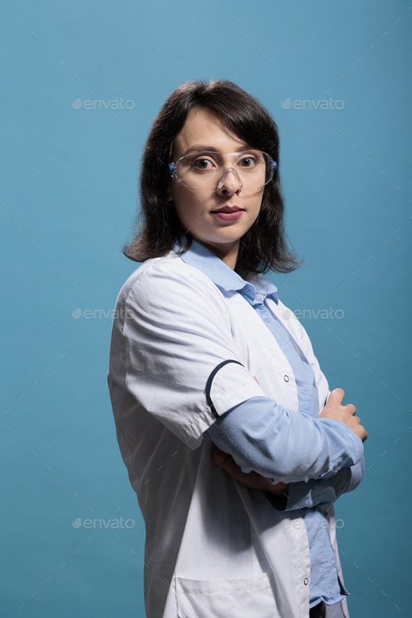 Biochemistry specialist wearing protective goggles and lab coat ...