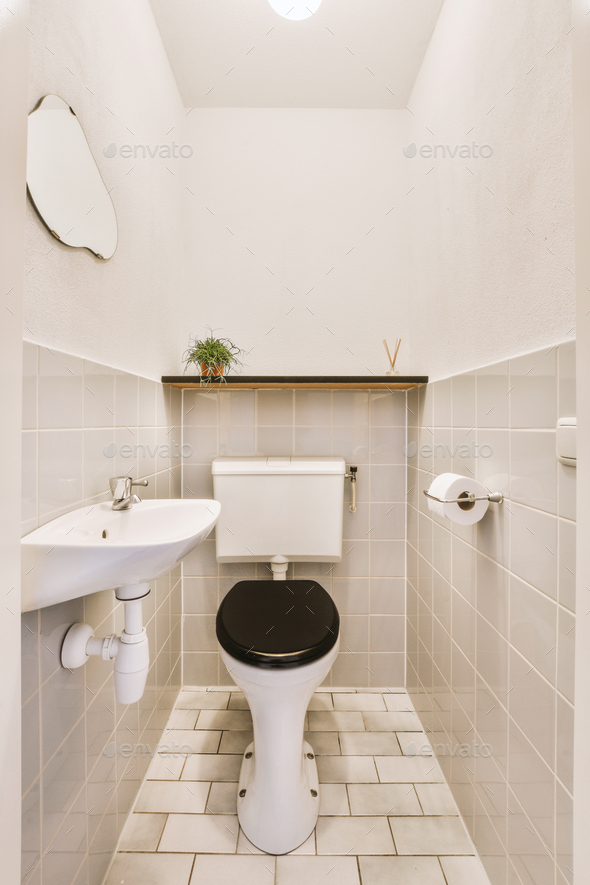 Narrow toilet room with minimalist design Stock Photo by pro_creator