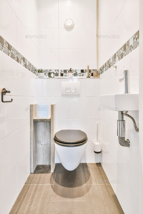 Narrow toilet room with minimalist design Stock Photo by pro_creator