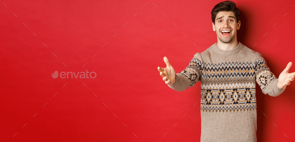 Image of happy and flattered handsome guy in christmas sweater ...