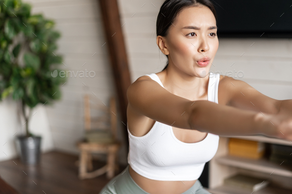 Young asian fitness woman with healthy fit body, doing squats, morning ...